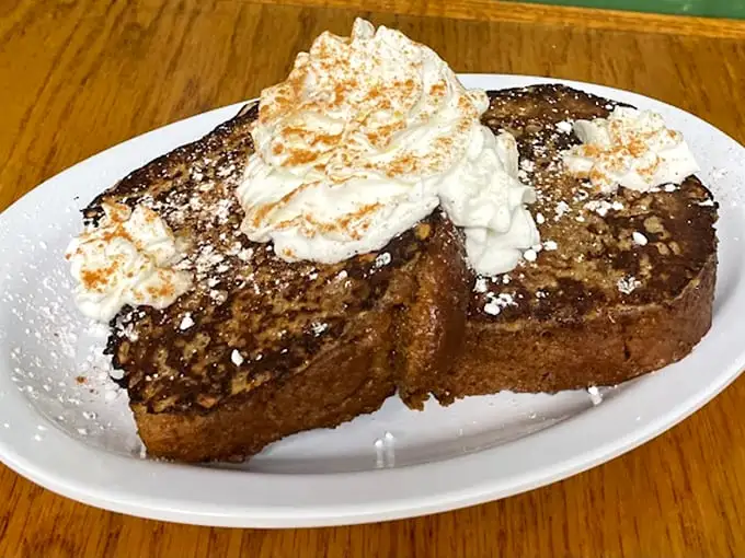French toast that doesn't need a filter—just your immediate attention. That whipped cream mountain isn't going to climb itself.