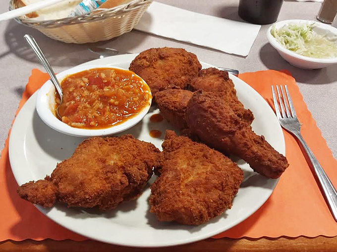 Golden-brown perfection that makes you want to write poetry. That hot sauce isn't about heat – it's a tangy tomato symphony that completes the chicken experience.