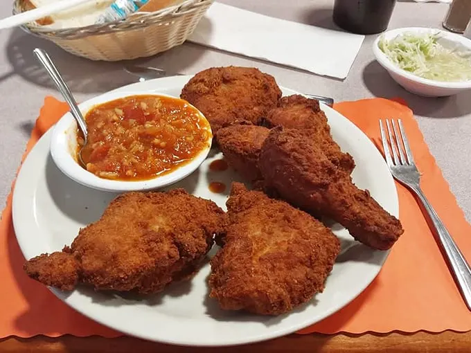 Golden-brown perfection that makes you want to write poetry. That hot sauce isn't about heat – it's a tangy tomato symphony that completes the chicken experience.
