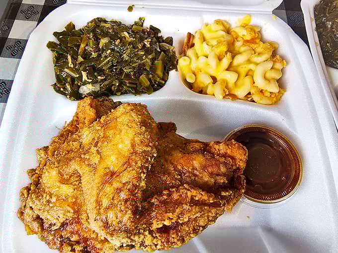Golden-brown perfection meets collard greens and mac and cheese – this isn't just a meal, it's edible joy.