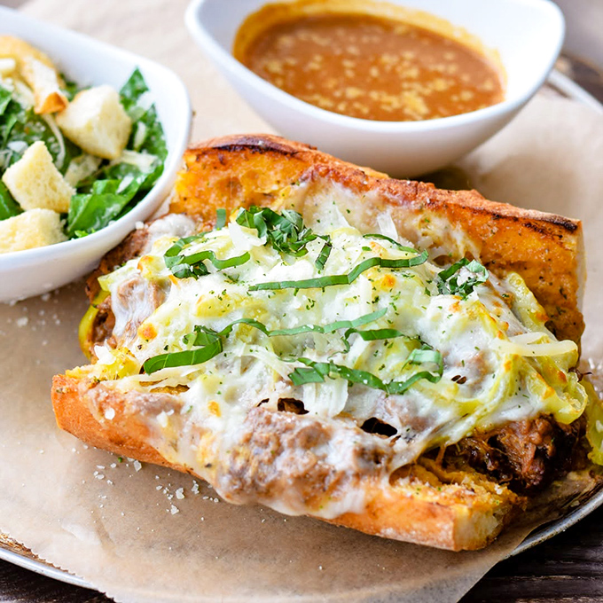 The sandwich that launched a thousand food dreams. Melty cheese blankets tender beef while pepperoncini adds zing—this is what happiness looks like on a plate.