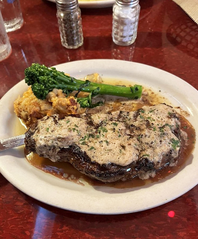 This isn't just a steak—it's a masterclass in the art of beef. The creamy sauce and perfectly cooked broccolini prove sides aren't afterthoughts here.