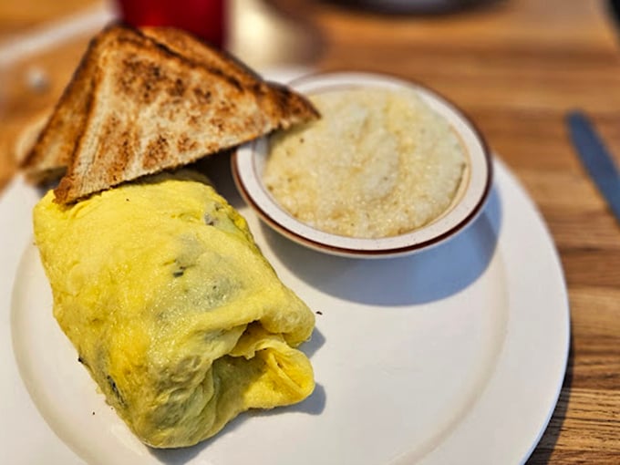 This omelet doesn't need Instagram filters – it's the real deal, fluffy and substantial, with a side of golden toast and grits.