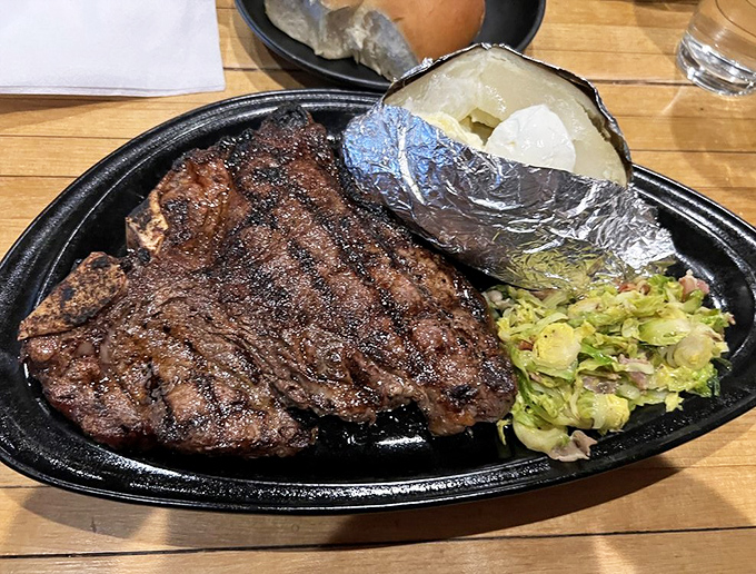 This porterhouse doesn't just sit on the plate—it commands it. Perfectly charred exterior, pink interior, and a baked potato standing by for backup.