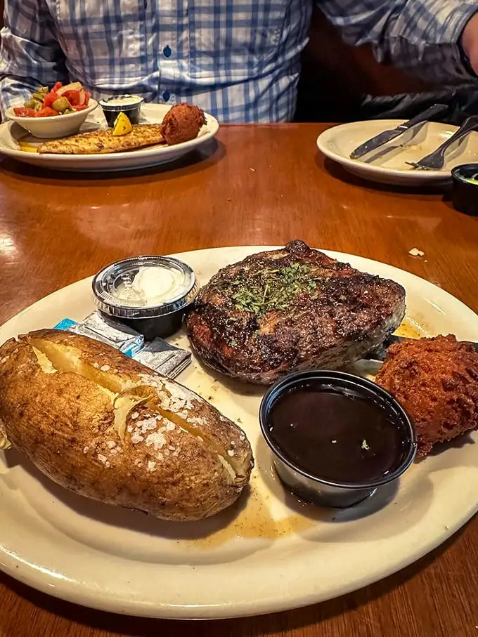 Steak night done right. That perfect char, a loaded baked potato, and a hush puppy that didn't stand a chance – this is Florida's answer to steakhouse royalty.