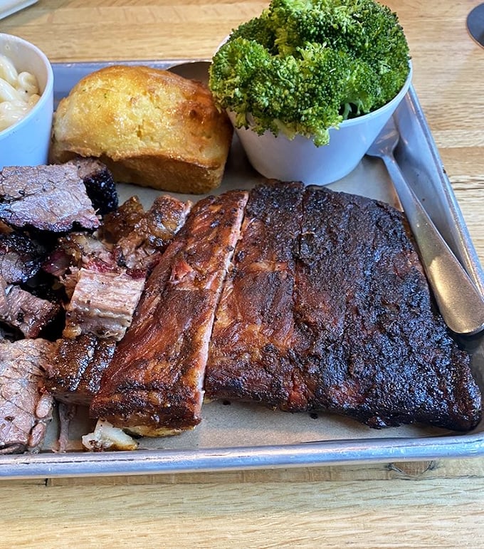 Behold the holy trinity of barbecue—ribs with that perfect bark, cornbread that doesn't know it's not cake, and sides that refuse to be upstaged.