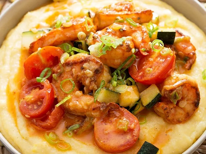Shrimp and grits so perfect they'd make a Charlestonian weep with joy. Those tomatoes add pops of color that say "this isn't your grandma's recipe."