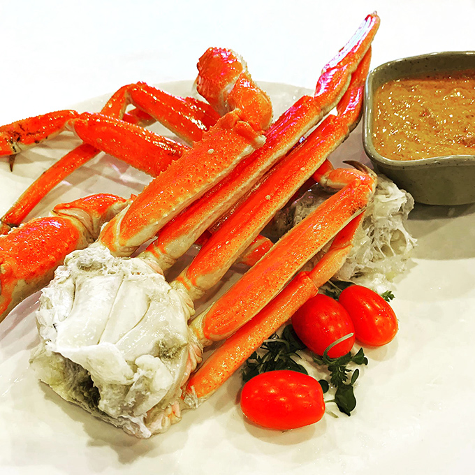Snow crab legs arranged like nature's sculpture—a crustacean masterpiece that requires only your hands and appetite as artistic tools.