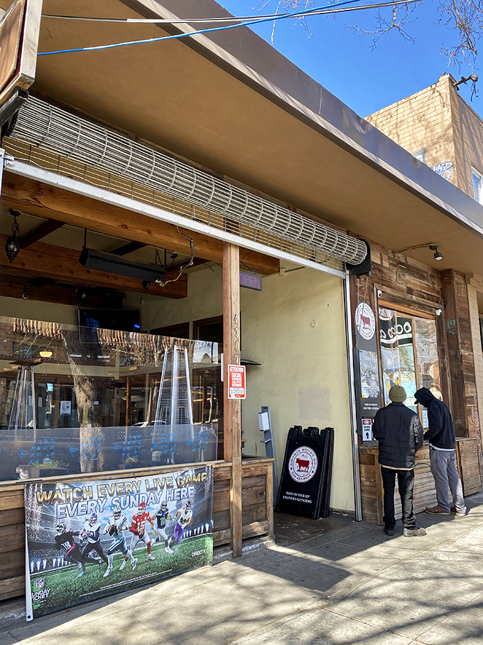 Smokin Woods BBQ might look unassuming, but that NFL banner hints at what locals know: this is where game day meets gourmet smoke.