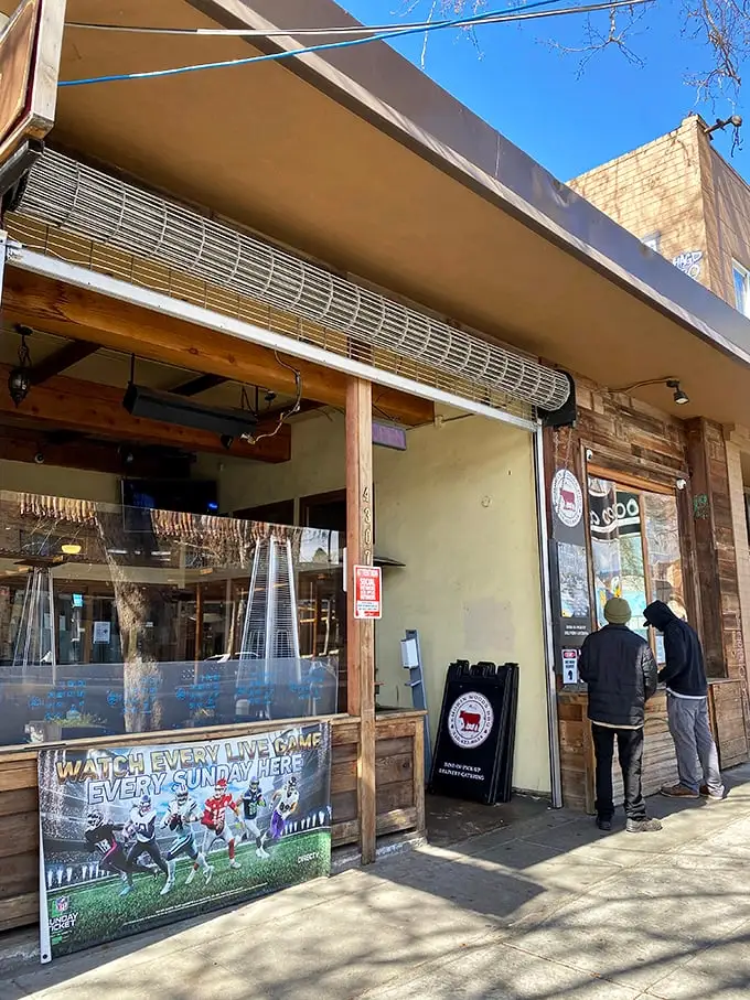 Smokin Woods BBQ might look unassuming, but that NFL banner hints at what locals know: this is where game day meets gourmet smoke.