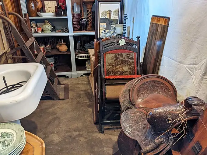 Western saddles and porcelain sinks—unexpected neighbors in this corner where the Wild West meets Victorian bathroom design.