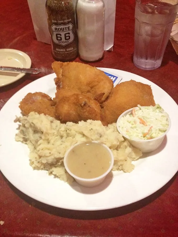 A proper chicken dinner comes with all the fixings—creamy mashed potatoes, gravy, and coleslaw. That Route 66 soda is the perfect nostalgic pairing for this roadside classic.