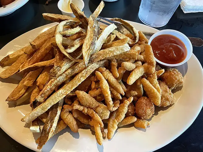 This isn't just fried seafood—it's an edible gold rush that makes your diet plans vanish faster than ice cream in August.