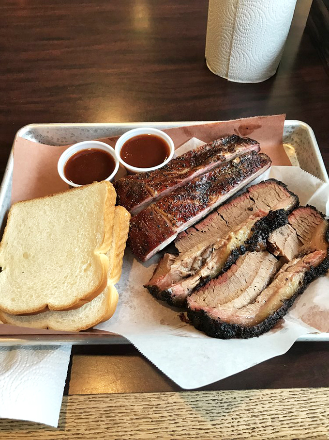 The barbecue board of your dreams—ribs with perfect bend, brisket with textbook smoke ring. Those two sauce cups are merely suggestions; this meat needs no enhancement.