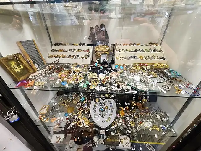 This jewelry display case contains more stories than a library—each brooch and ring once marked celebrations now waiting for new chapters.