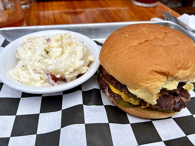The classic Arnold burger with potato salad on a checkered paper—proof that perfection doesn't need fancy plating, just honest ingredients and know-how.