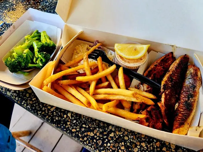 The perfect trifecta: golden fries, vibrant broccoli, and blackened mullet that would make Neptune himself swim to shore.