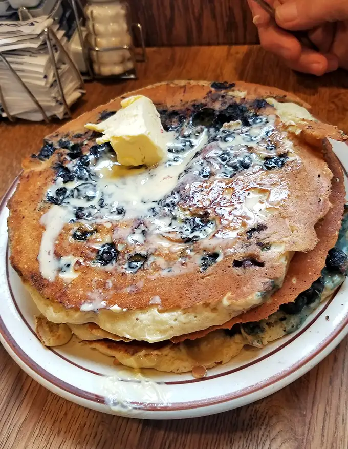 These blueberry pancakes aren't just breakfast, they're an edible hug with butter melting like a sunrise on top.