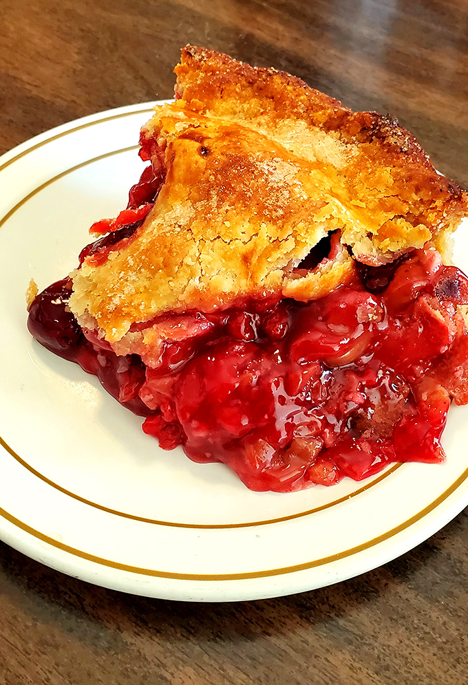 Cherry pie so vibrant it practically glows, with filling that strikes that magical balance between sweet and tart—the holy grail of pie perfection.