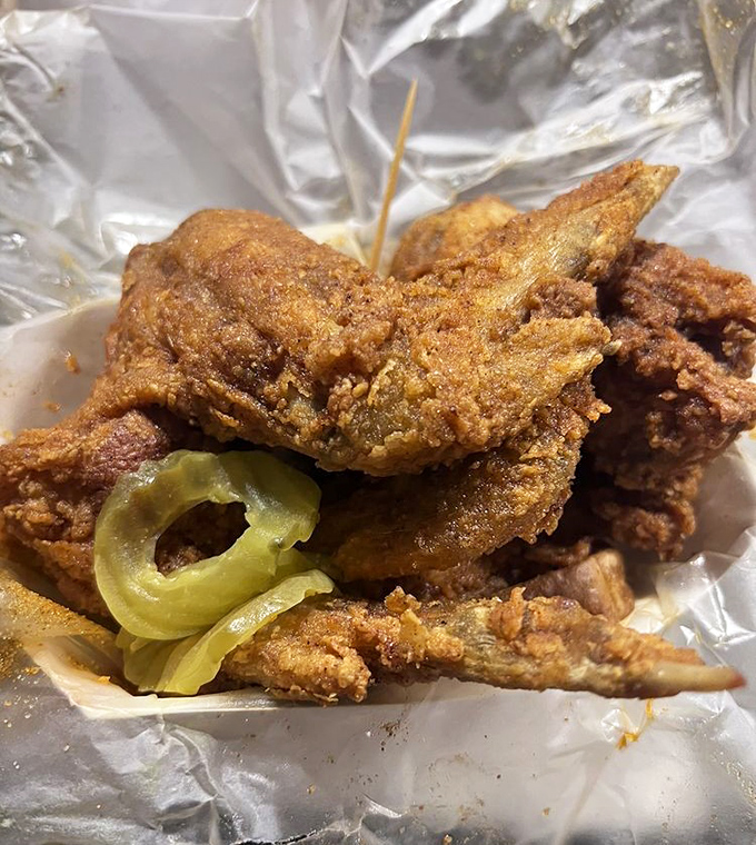 Golden-fried wings with pickle chips—nature's coolant system for the impending heat wave about to hit your taste buds.