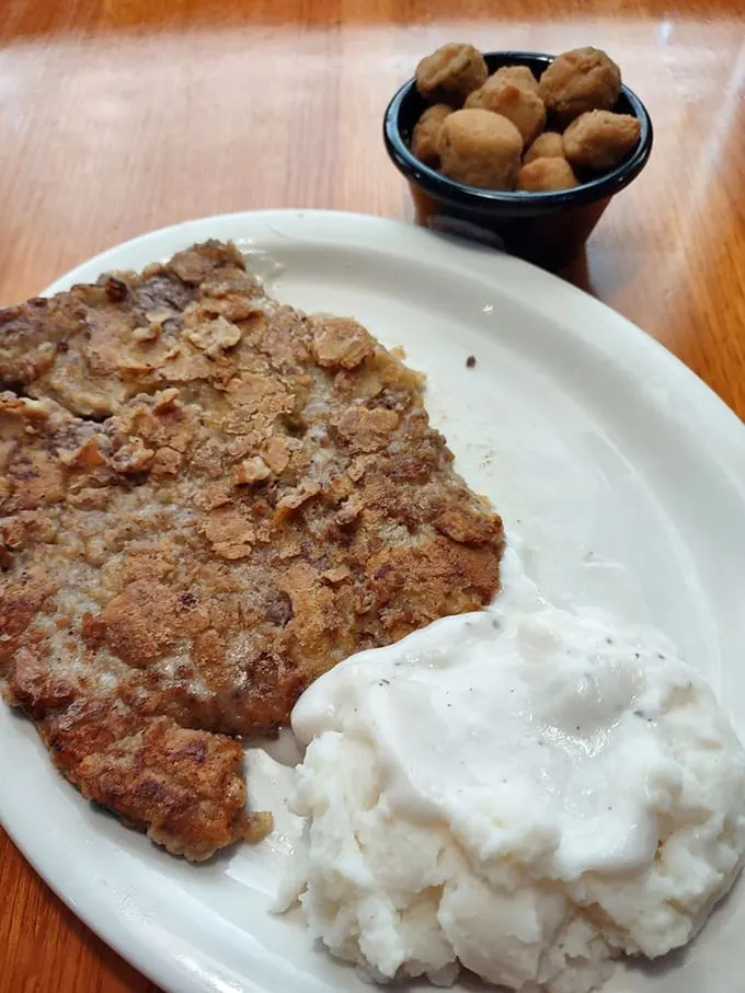 This chicken fried steak doesn't need fancy garnishes—just a side of mashed potatoes and a small bowl of okra to keep it company.