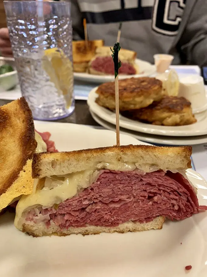 When a corned beef Reuben reveals its cross-section, it's like seeing the Grand Canyon for the first time—layers of beauty that make you wonder how you lived without it.
