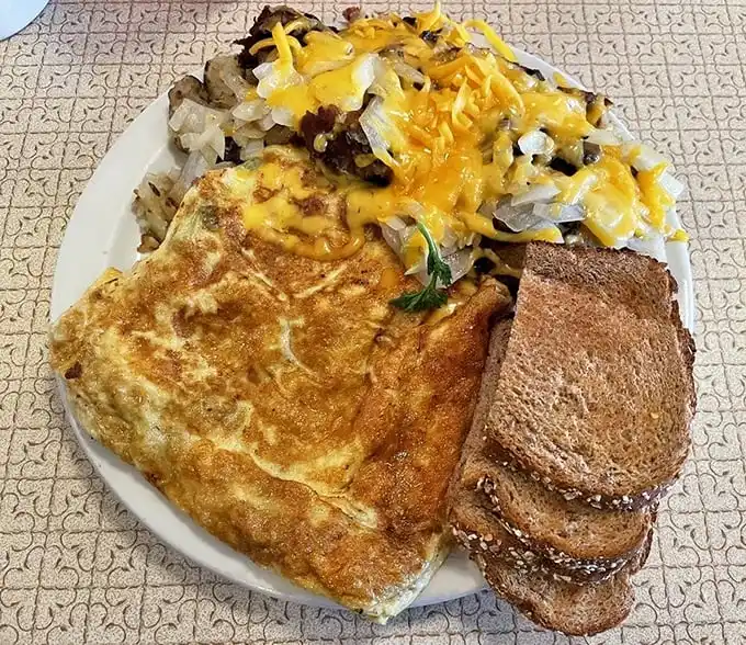 The Denver omelet doesn't just arrive—it makes an entrance, wearing a crown of melted cheddar and surrounded by a royal court of hashbrowns.