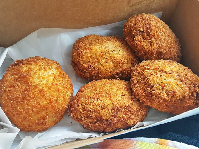 These golden orbs of deviled crab goodness aren't just fried—they're transformed. Four perfect specimens waiting to make your acquaintance.