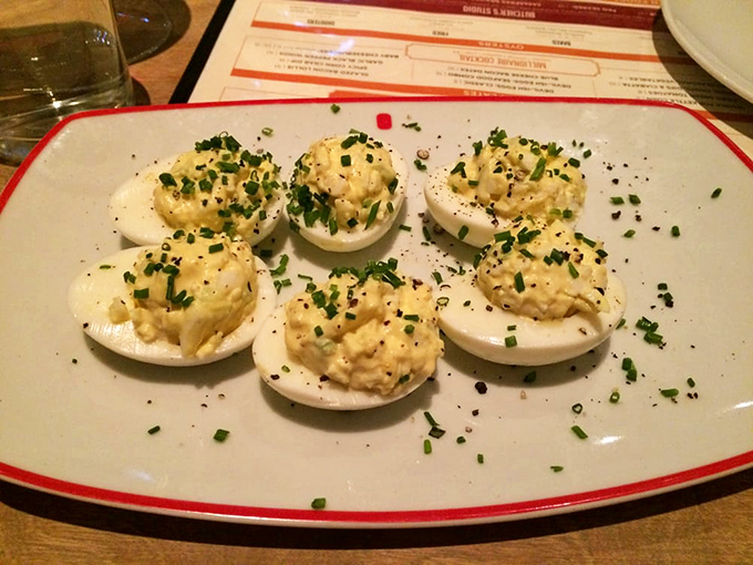 The humble deviled egg, reimagined with meticulous attention to detail. Fresh chives sprinkled atop creamy yolk filling create a perfect two-bite appetizer that disappears all too quickly.