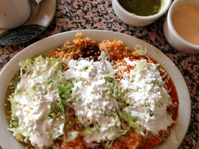 Supreme indeed! Those enchiladas wear their toppings like a crown—sour cream, lettuce, and cheese creating a beautiful mess worth every napkin.
