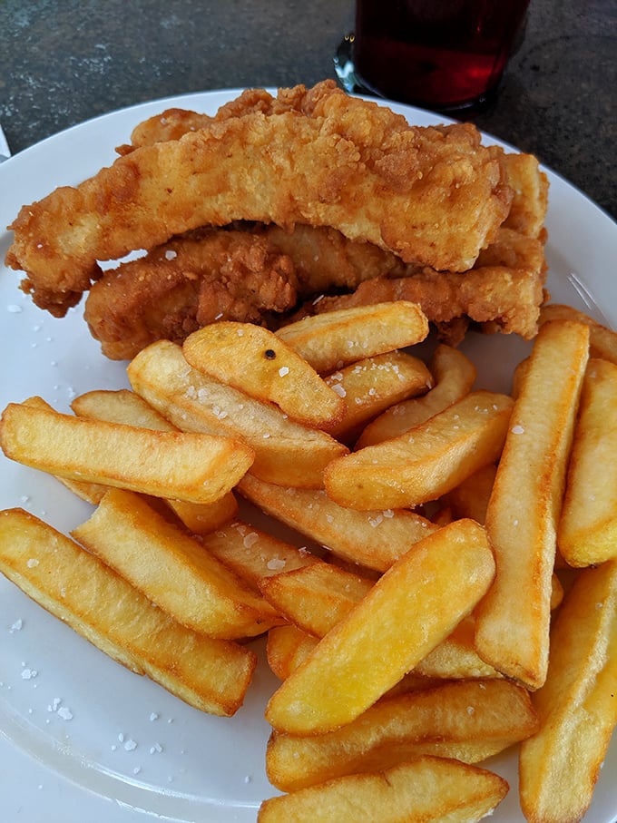 The Fish and Chips arrive looking like they just won a golden-brown beauty pageant – crispy, substantial, and demanding to be doused in malt vinegar.