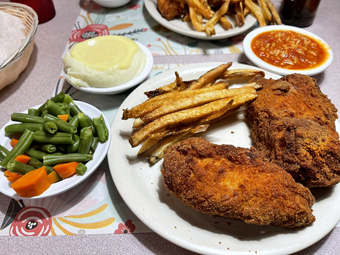 A complete Barberton chicken feast with all the fixings. Green beans, mashed potatoes, and that legendary hot sauce create the holy trinity of comfort.