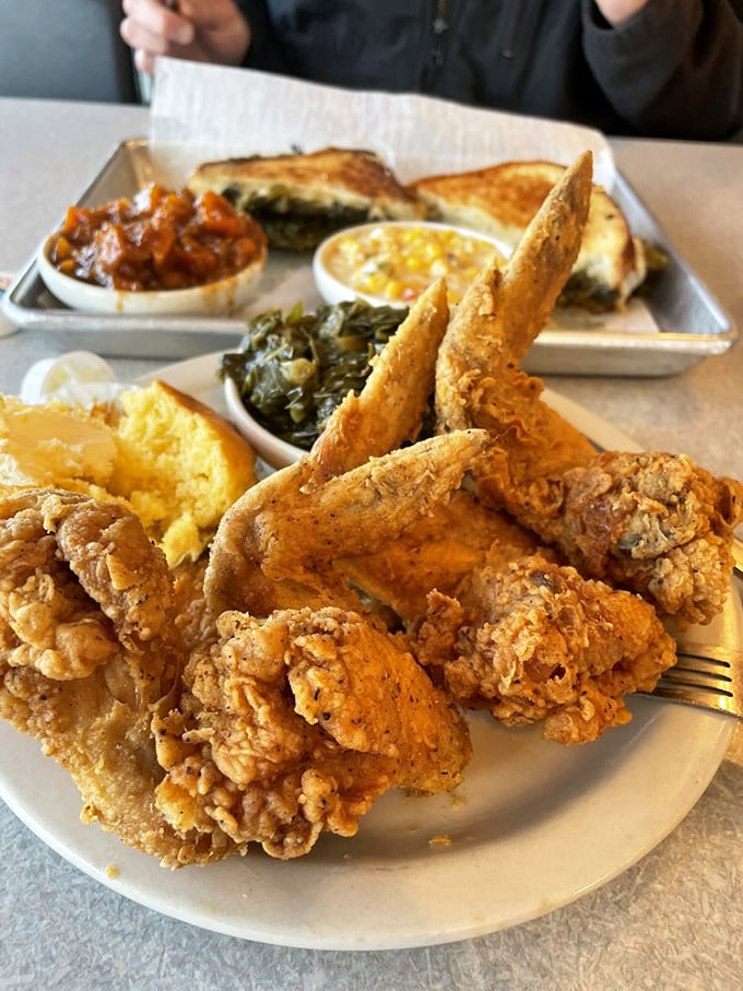 This isn't just lunch—it's edible artwork. Crispy chicken, tender greens, and cornbread that would make angels weep with joy.
