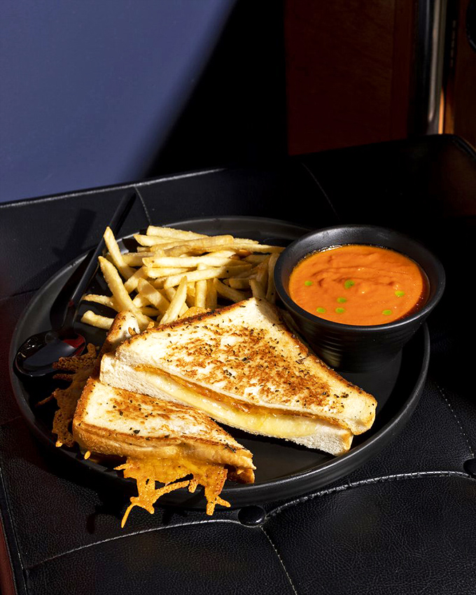 Dipping this perfectly toasted sandwich into that vibrant tomato soup isn't just eating—it's participating in one of life's most perfect culinary relationships.