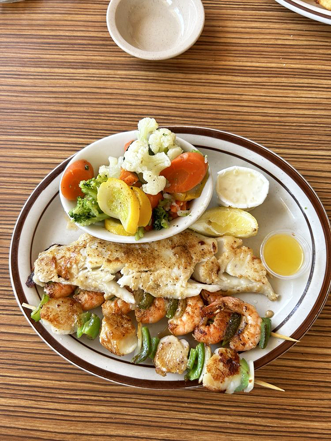 The grilled seafood platter—where vegetables are merely supporting actors in this ocean-to-table drama starring perfectly seasoned shrimp and fish.