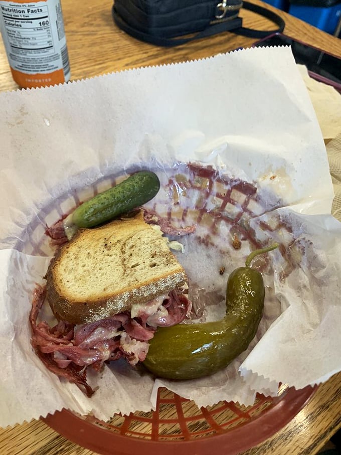 The half-eaten Reuben tells the real story—it was too good to wait for a photo. Those pickles aren't garnish; they're supporting actors deserving their own Oscar.