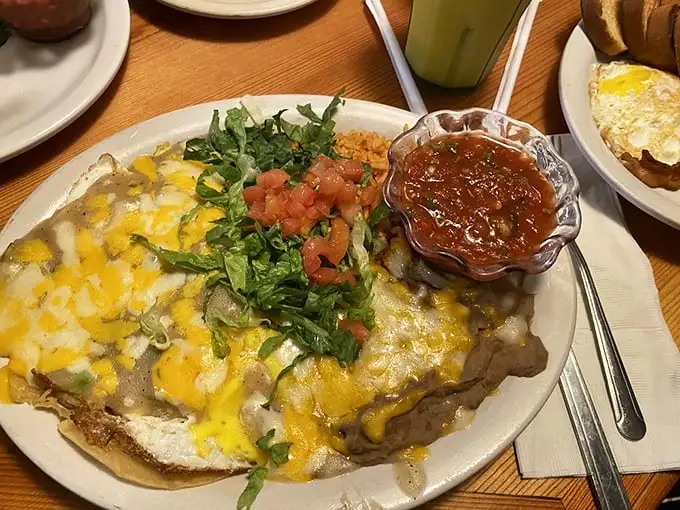 This plate of huevos rancheros isn't just breakfast—it's a fiesta. The melted cheese blanket keeps everything warm for the party.