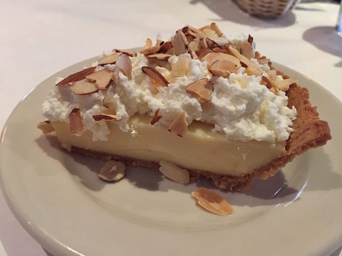 This coconut cream pie with toasted almonds isn't just a dessert—it's what clouds must taste like if they were made by a Southern grandmother with something to prove.