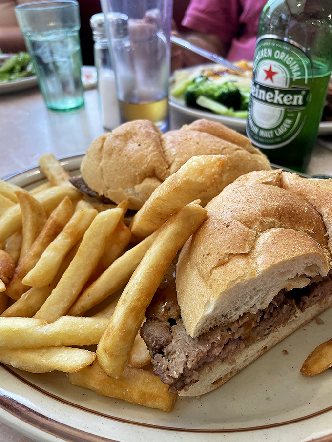 This sandwich isn't just lunch—it's an architectural masterpiece of bread, meat, and crispy fries that demands both hunger and strategy.