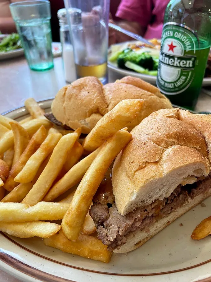 This sandwich isn't just lunch—it's an architectural masterpiece of bread, meat, and crispy fries that demands both hunger and strategy.