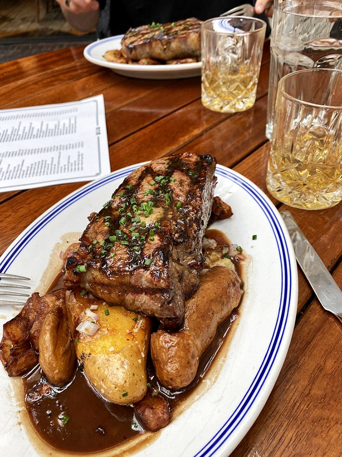 When your steak arrives with potatoes bathing in that glorious reduction, paired with a proper whiskey—life achievements unlocked.