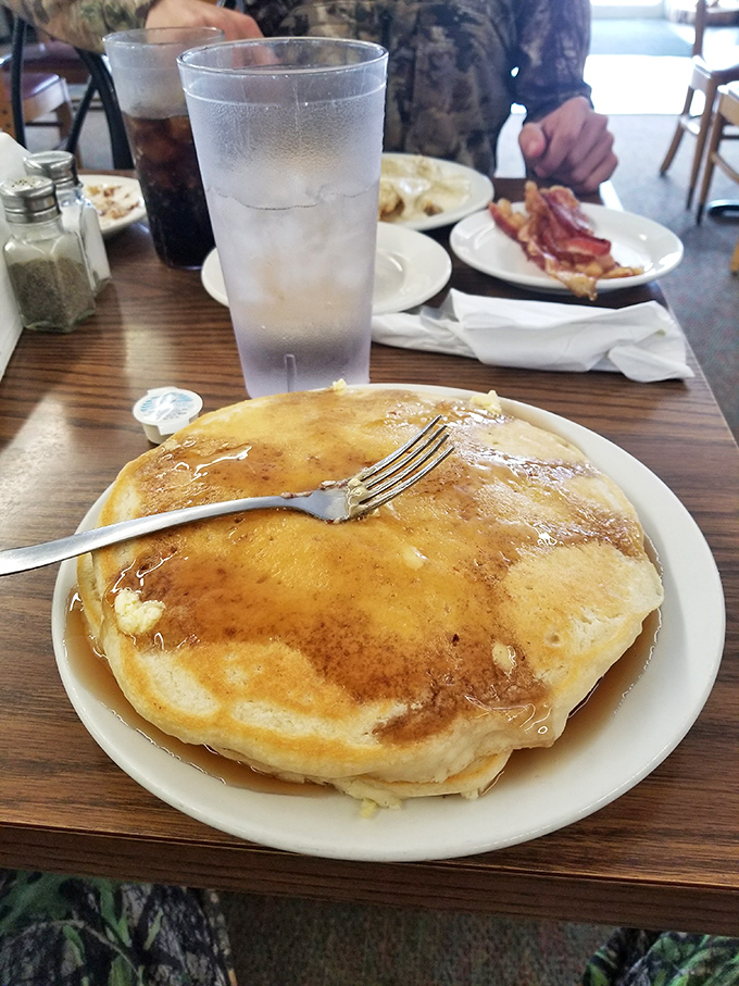 These pancakes aren't just breakfast, they're an edible pillow of happiness. The maple syrup river adds the perfect sweet finale.