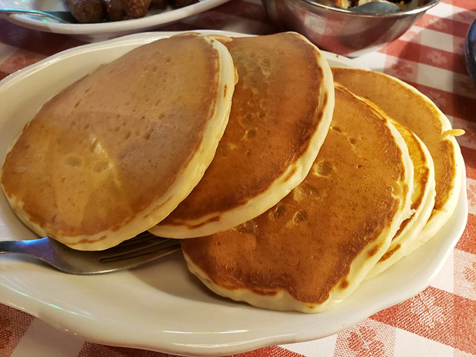 These aren't just pancakes—they're golden discs of happiness stacked higher than my cholesterol after eating them. Worth every delicious bite!