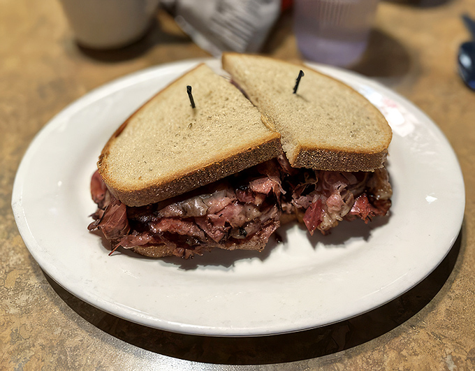 Pastrami piled so high it needs a support system. This isn't just a sandwich—it's an architectural marvel of deliciousness.