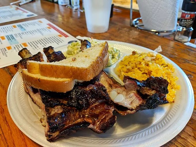 Barbecue architecture at its finest: ribs, bread, and sides arranged in perfect harmony like a meat-lover's symphony.