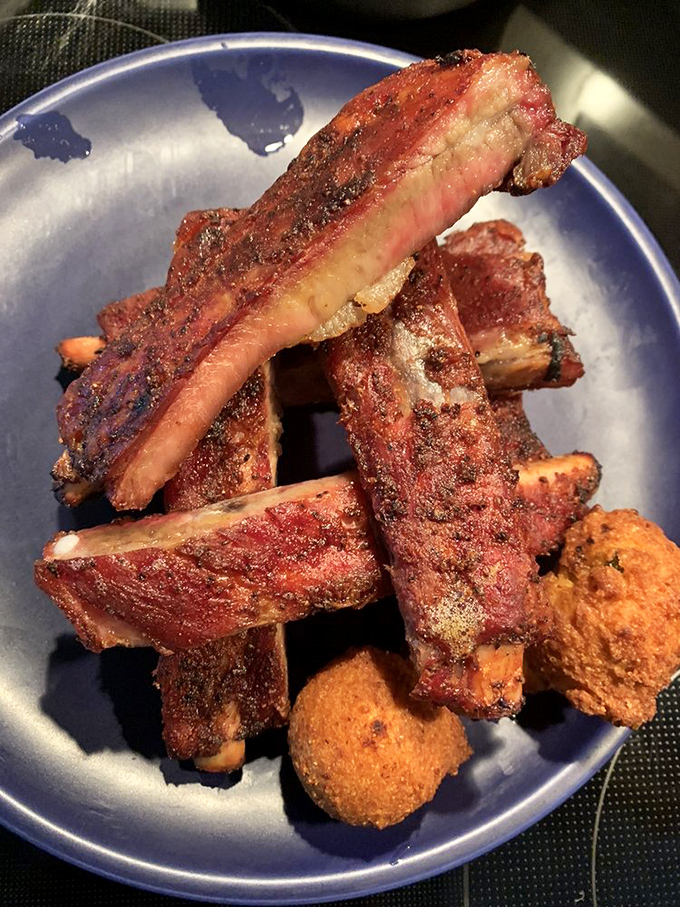 These ribs have the kind of bark that commands attention. The meat's not falling off the bone—it's holding on just enough to maintain its dignity.