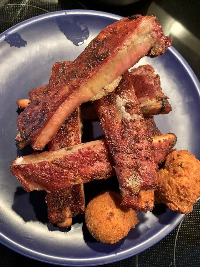 These ribs have the kind of bark that commands attention. The meat's not falling off the bone—it's holding on just enough to maintain its dignity.