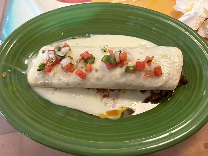 Behold the San Jose Burrito in all its glory—wrapped in white cheese blanket and topped with fresh pico de gallo. Resistance is futile, my friends.