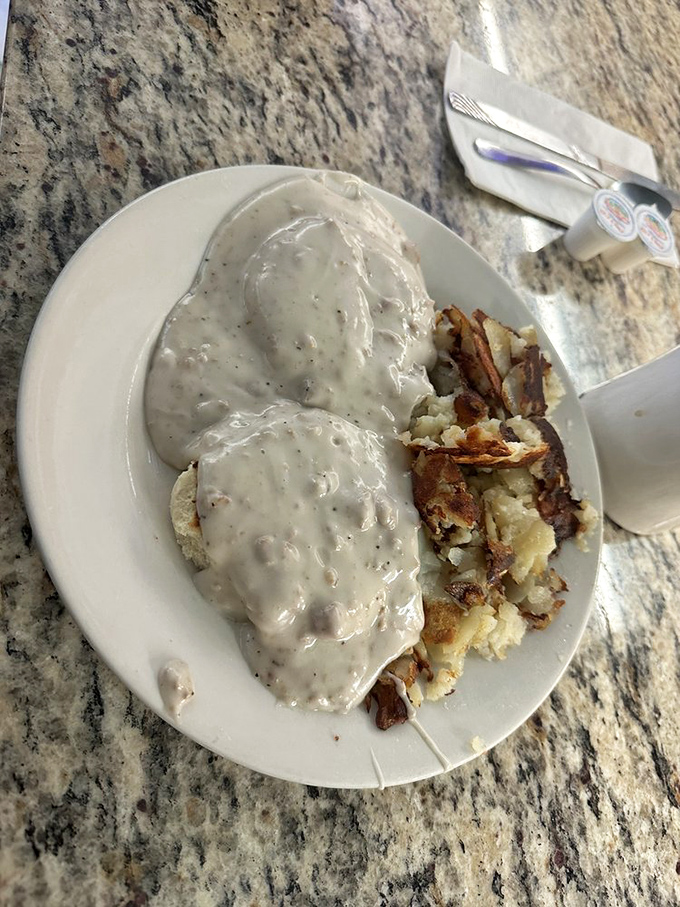 Biscuits and gravy—the breakfast equivalent of a warm hug from your grandmother, if your grandmother had a PhD in comfort food engineering.