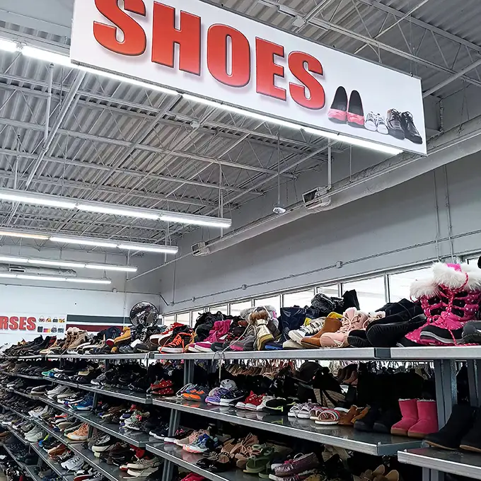 Under the commanding "SHOES" sign lies a thrifter's footwear fantasy. From practical flats to statement heels, yesterday's fashion awaits tomorrow's adventures.
